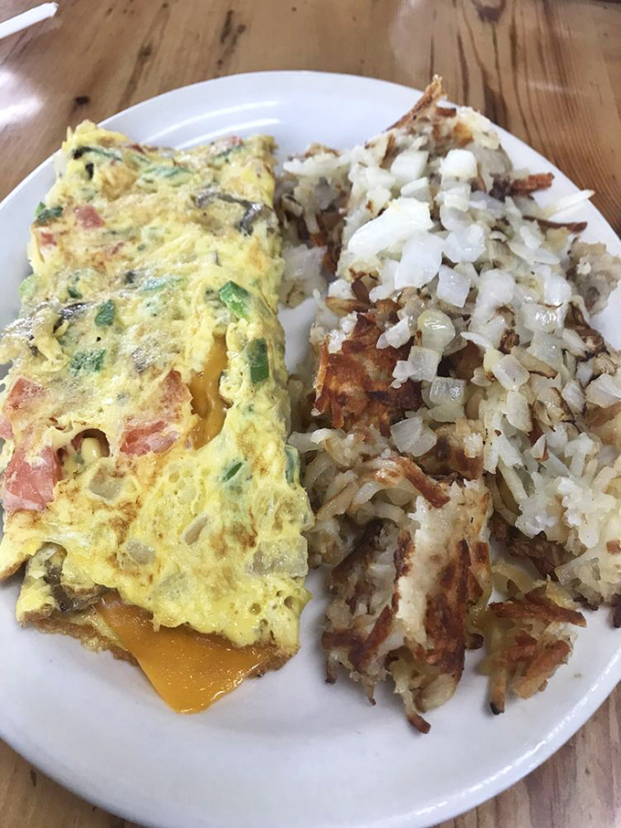 Veggie victory! This colorful omelet proves that eating your greens can be a delicious adventure, especially when wrapped in fluffy eggs.