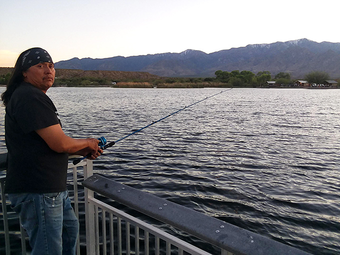 The early bird gets the... fish? This angler knows the secret to a perfect morning: a rod, a reel, and a view.