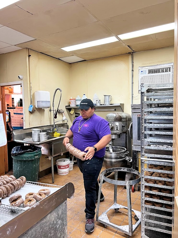 Behind the scenes of deliciousness. This kitchen magician is crafting edible works of art, one donut at a time.