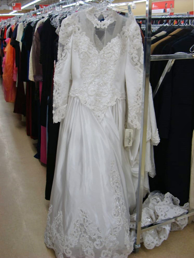 Something old, something new, something borrowed, something... thrifted? This vintage wedding dress whispers tales of romance from another era.