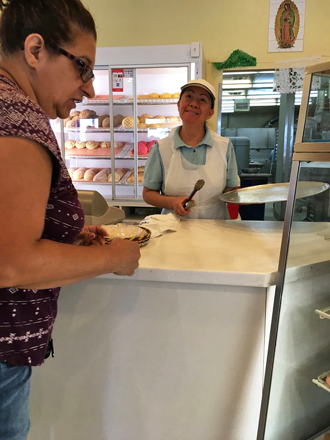 Behind the scenes of deliciousness. This baker's smile says it all - she's about to make someone's day a whole lot sweeter.