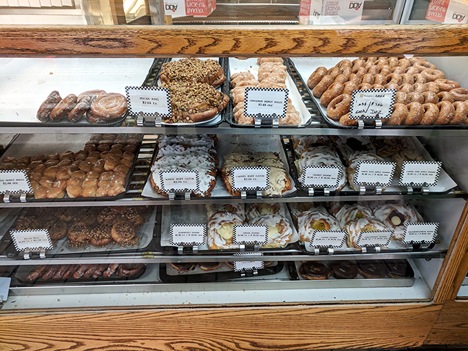 A smorgasbord of sweetness! This case is like a United Nations of pastries, where every delegate is vying for your vote (and your stomach).