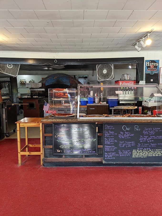 Pizza perfection in progress! Sam's open kitchen lets you watch the magic happen as pies transform from dough to delicious.