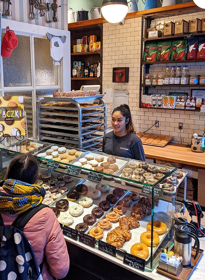 The donut whisperer at work! This skilled artisan is crafting edible joy, one ring at a time.