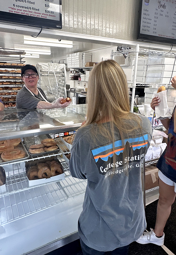Donut wizards at work! These skilled staff members are the Willy Wonkas of the South, turning simple ingredients into pure magic.