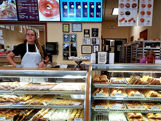 The donut whisperer at work! This skilled artisan is the Willy Wonka of the bakery world, creating magic one pastry at a time.