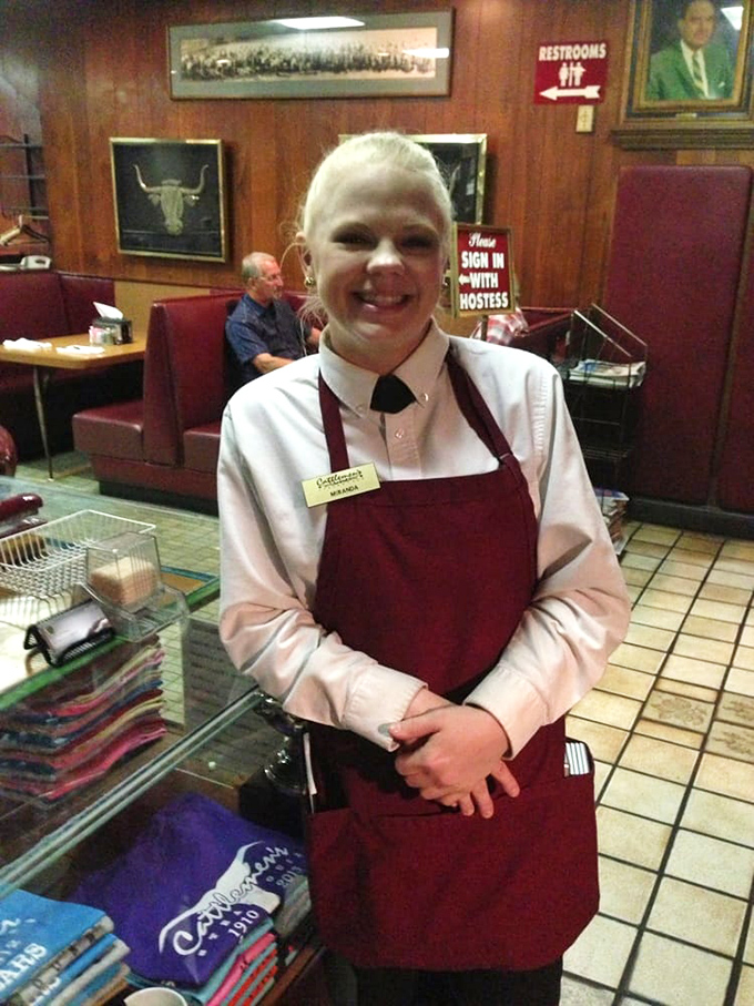 The image shows a staff member in the restaurant's interior.