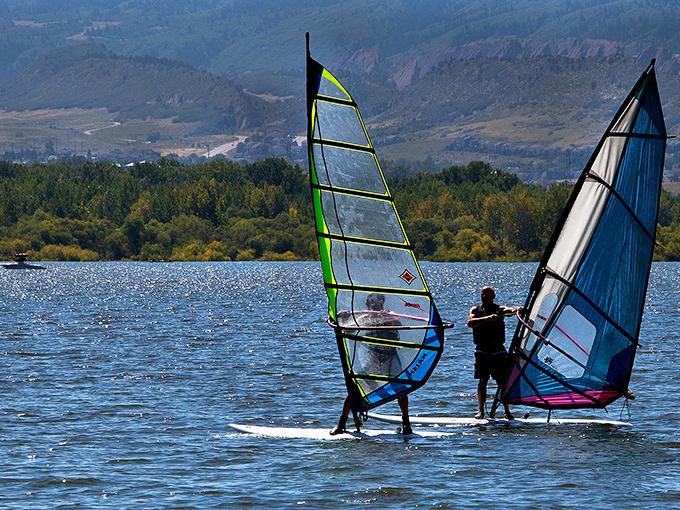 Wind-powered wanderlust: These windsurfers are like modern-day explorers, harnessing the breeze to conquer Sweitzer's liquid landscape. Talk about a natural high!