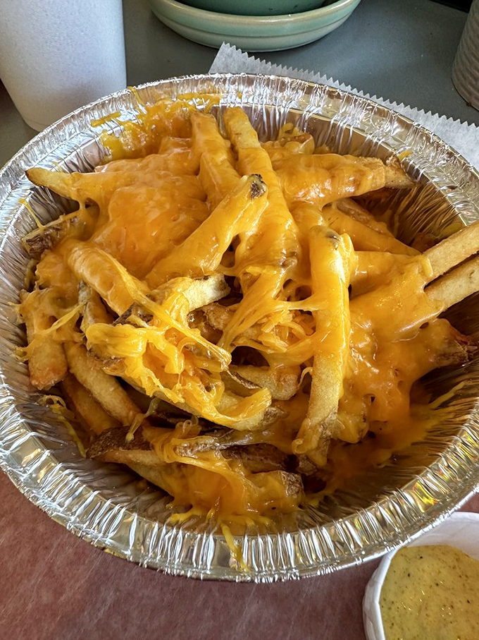 Cheese fries that make you weak in the knees! This gooey masterpiece is what happens when potatoes dream big.
