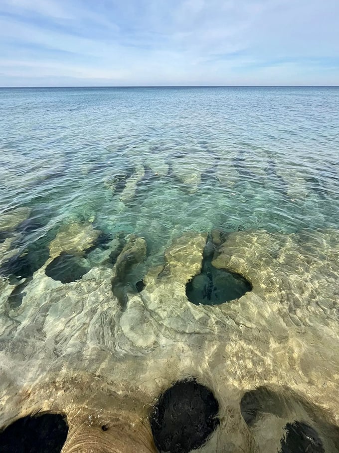 Nature's Swiss cheese: Lake Superior's clear waters reveal a rocky bed full of holes. No cheddar here, just pure Michigan magic.