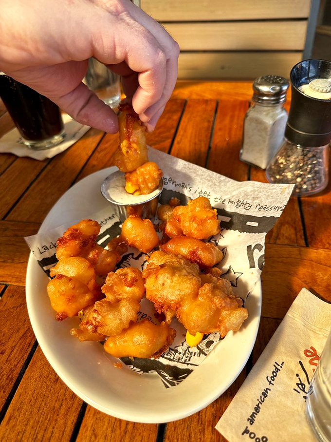 Cheese curds that squeak louder than your old gym shoes. Fried to golden perfection, they're the ultimate guilty pleasure.
