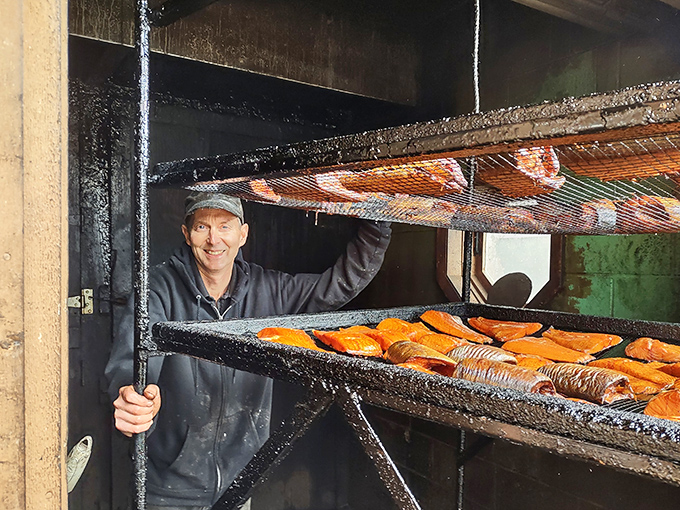 Meet the maestro of marine munchies! This guy's not just smoking fish, he's crafting edible symphonies in a cedar-scented steam room.