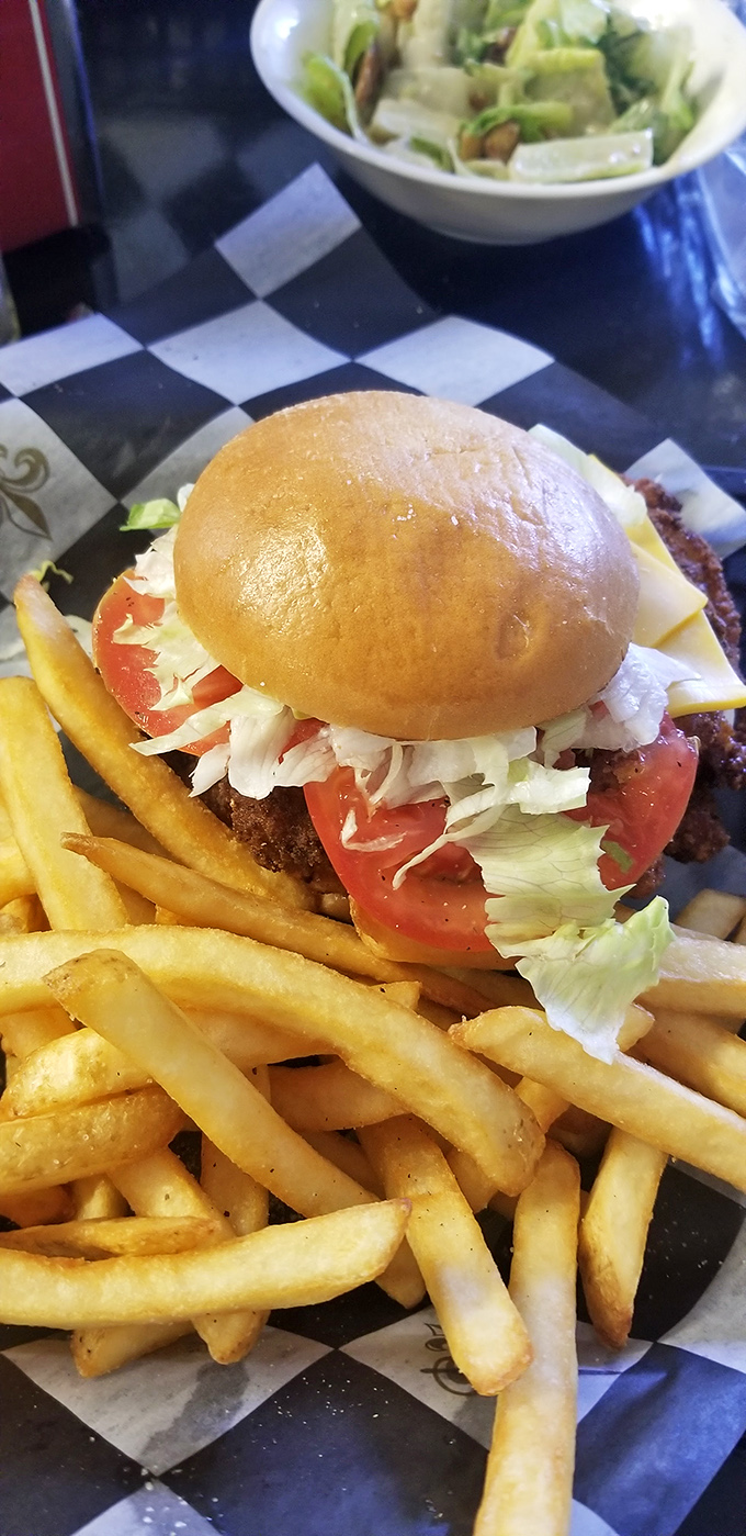 Burger bliss achieved! This juicy masterpiece, flanked by crispy fries, is the stuff food dreams are made of.