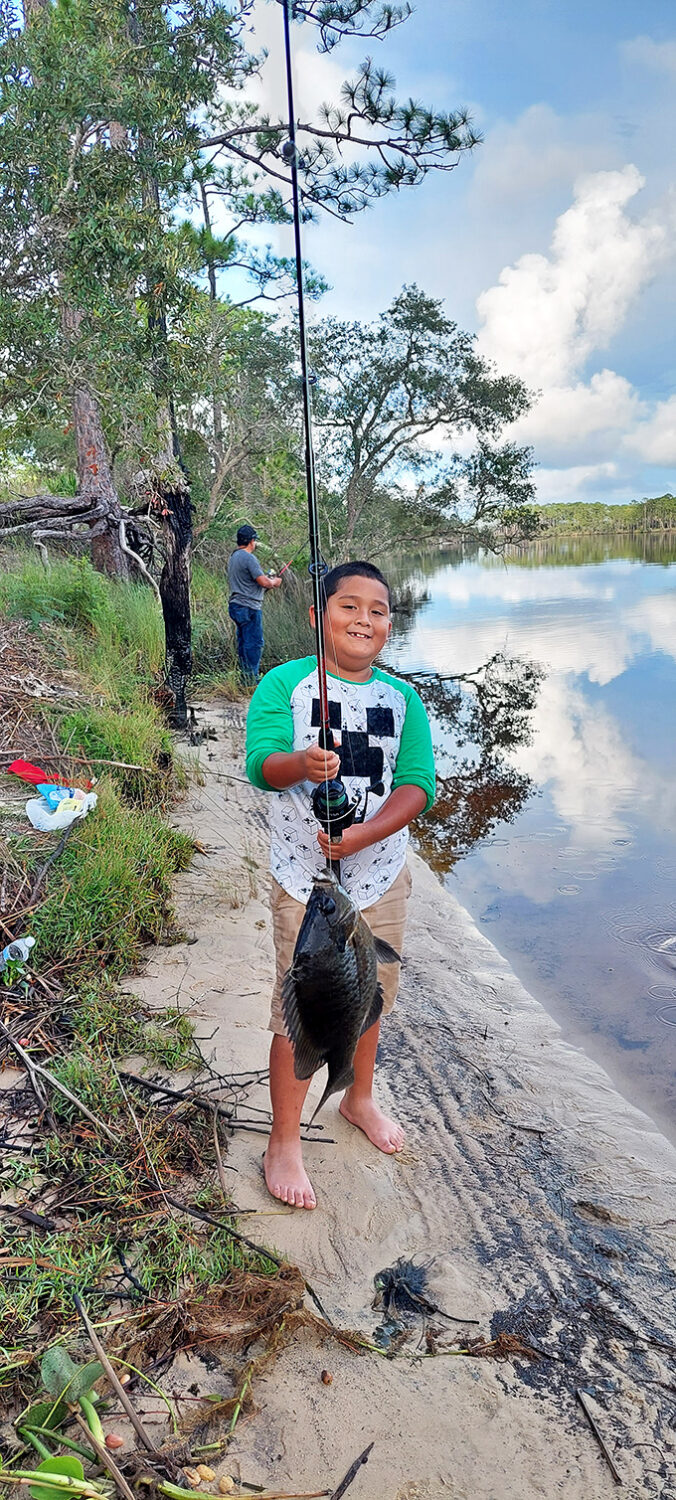 The catch of the day: Pure joy with a side of fish. This young angler's smile is brighter than a Florida sunrise.