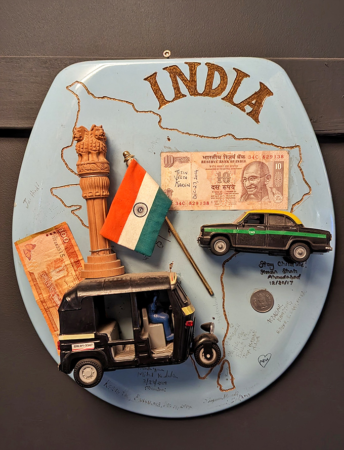 India in miniature, complete with rupees and rickshaws. A whole subcontinent's culture, condensed onto a commode lid!