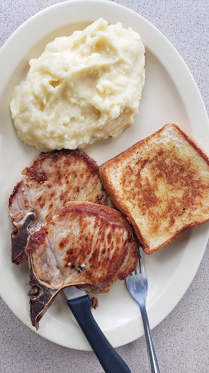 Pork chops and pillowy mashed potatoes: a match made in comfort food heaven. It's like a warm hug for your taste buds!