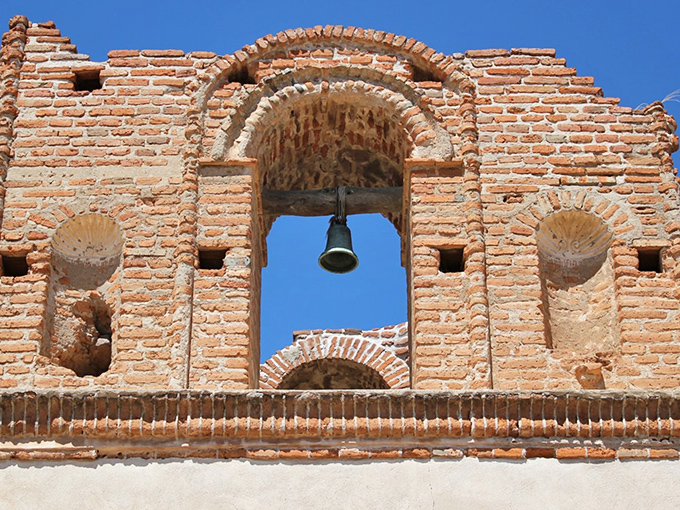 The mission's bell, a silent sentinel of time. If these bricks could talk, they'd probably say, "For whom the bell tolls? It tolls for thee, tourist!"