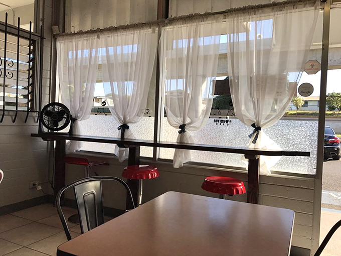 Window seats with a view and stools redder than a sunburned tourist. Perfect for people-watching or plotting world domination.