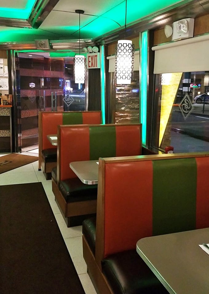 Cozy booths bathed in a neon glow – it's like sitting in your own personal time machine with a side of fries.