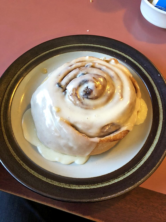 Holy sweet tooth, Batman! This gooey cinnamon roll, dripping with frosting, is so indulgent it should come with a warning label.
