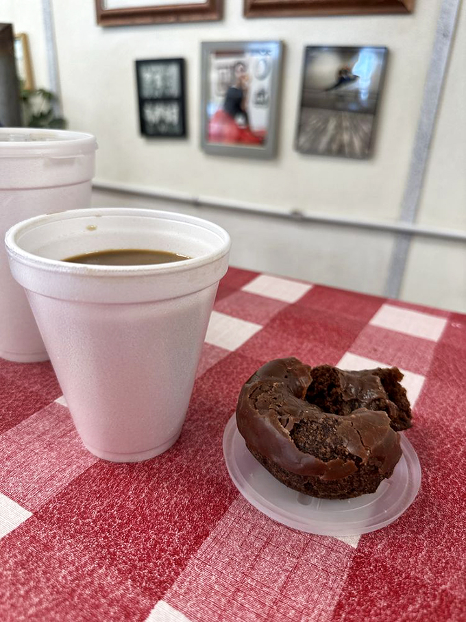 The perfect pairing: a steaming cup of joe and a chocolate-glazed delight. It's breakfast of champions... if the champions are donut enthusiasts.