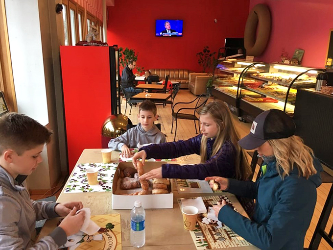 Family bonding over frosted delights! These young explorers embark on a sugary safari, proving that donut appreciation is a skill best learned early and often.