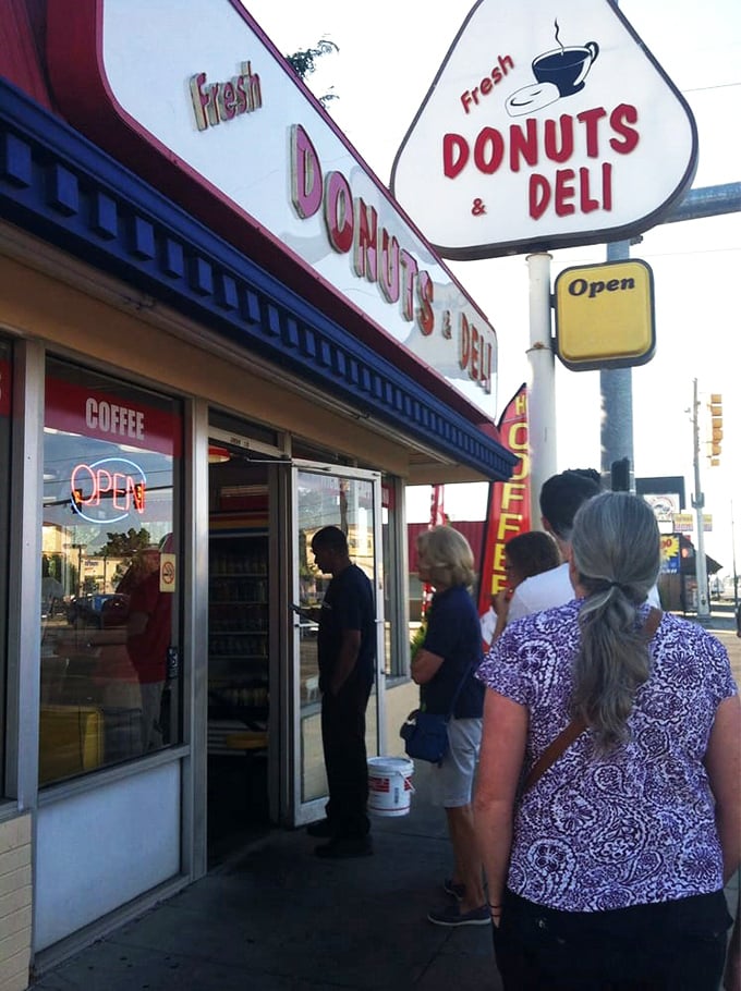 The line forms here for happiness! These eager customers know that good things come to those who wait... for fresh donuts.