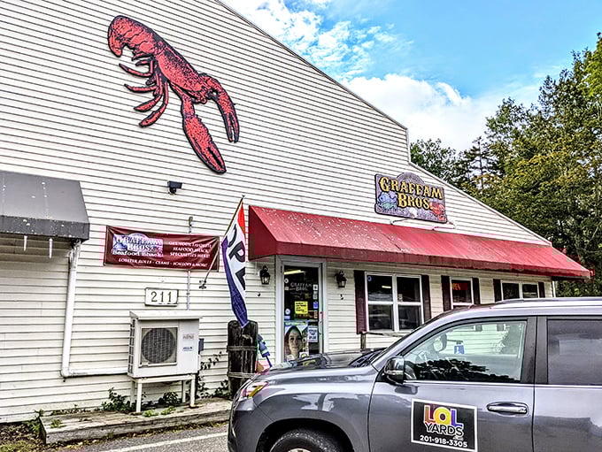 Graffam Bros' giant red lobster sign serves as a roadside beacon, guiding hungry travelers to seafood nirvana.