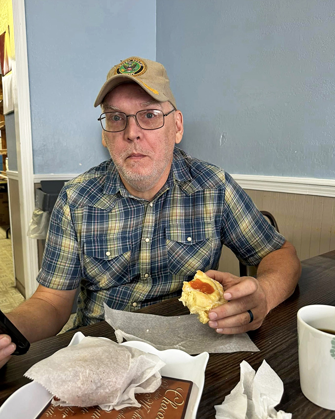 A moment of pure joy captured: Man vs. Pastry. Spoiler alert &ndash; everyone's a winner in this delicious showdown.