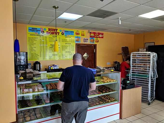 Decisions, decisions! This customer is living the dream, faced with a dazzling array of donut delights.