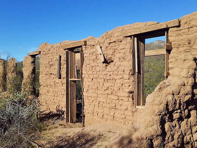 Adobe ruins stand as silent witnesses to frontier life, their empty windows framing the same desert vistas as a century ago.