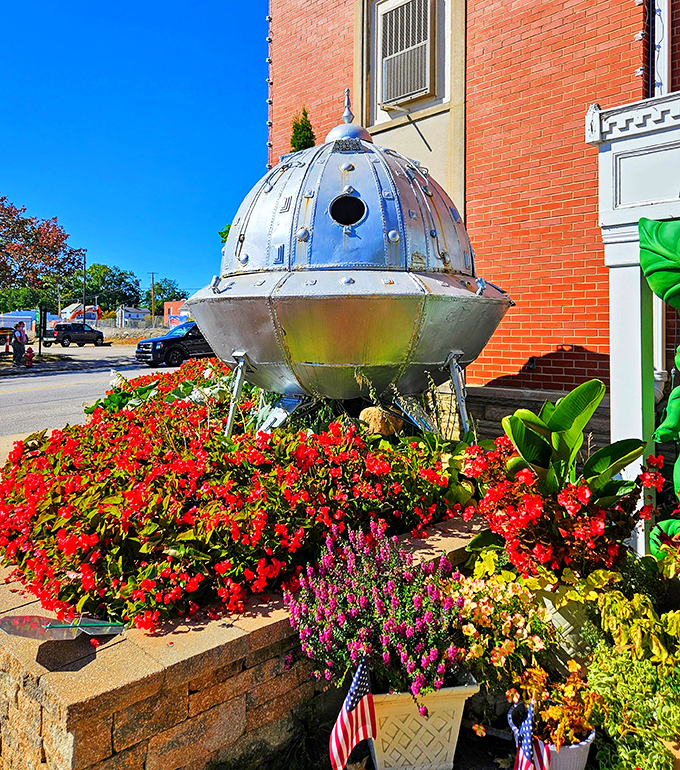 "Houston, we have a flower problem." This grounded UFO proves that even aliens appreciate a good garden when they're not crop circling.