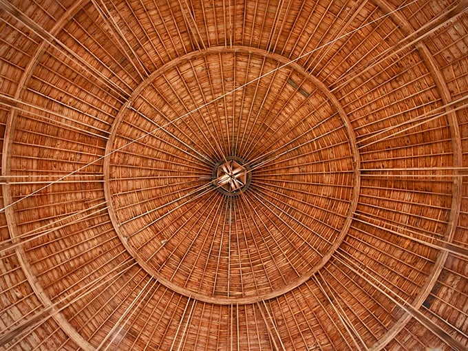 Look up and prepare to be a-moo-sed! The barn's intricate ceiling is a wooden wonder, radiating out like the world's most impressive pie chart.
