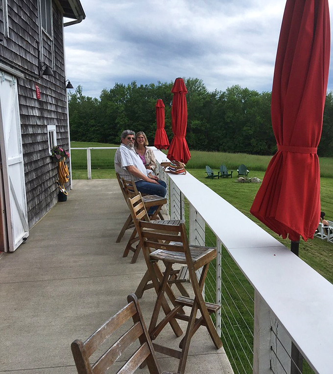 Perched on the patio, you're the king of the vineyard. Red umbrellas stand ready to shield you from sun or rain – nothing gets between you and your wine!
