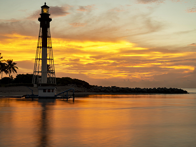 Mother Nature's showing off again with a sunset that looks like it was painted by Bob Ross himself. Happy little lighthouse, indeed!