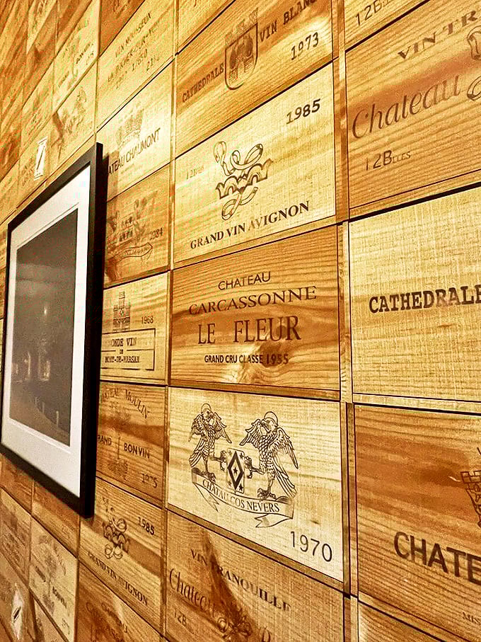 A wall of wooden whispers: Each crate tells a story of vintages past. It's like a library, but way more fun.