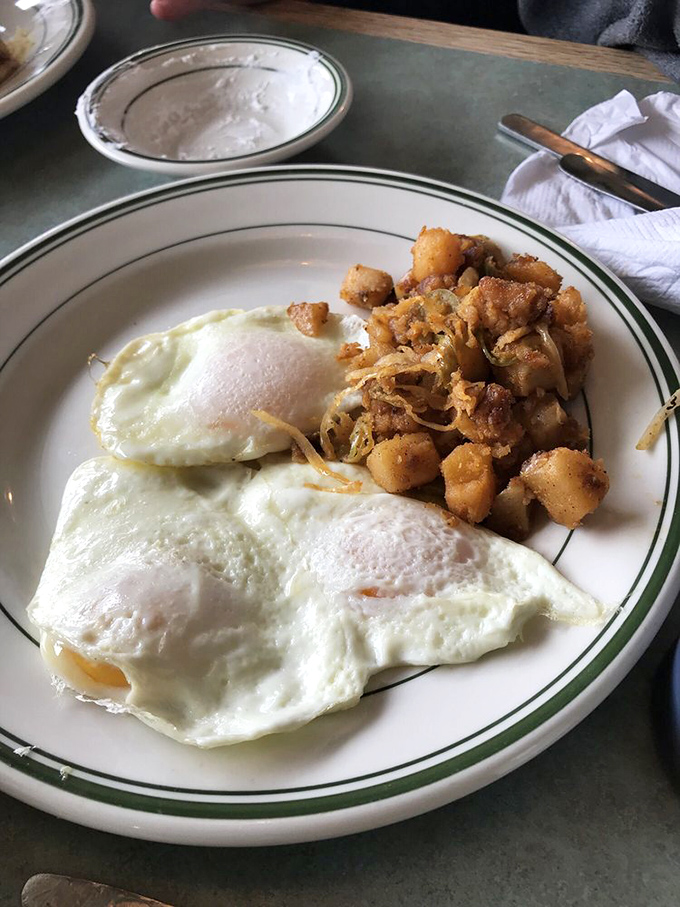 Sunny-side up eggs with a side of crispy potatoes. Simple perfection that proves sometimes the best things in life really are over-easy.