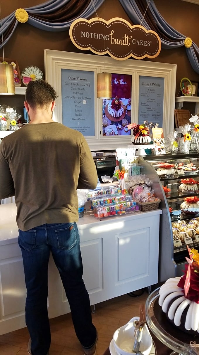 Decisions, decisions! This customer ponders life's greatest question: which bundt flavor will bring ultimate happiness today?