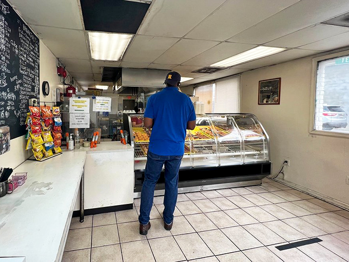 Decisions, decisions! This customer ponders life's greatest question: which donut to choose? It's like Sophie's Choice, but delicious.