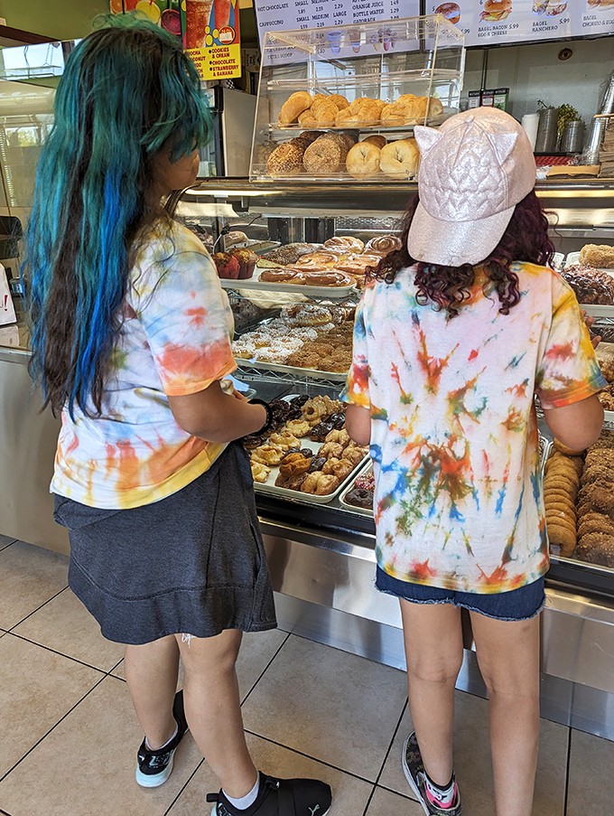 Donut dilemma in progress! These customers are facing the sweetest Sophie's Choice imaginable – which delectable treat to choose?