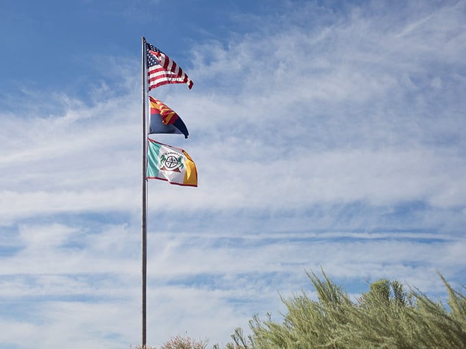 Three flags flutter in the breeze, telling a story of cultures intertwined. It's like a fabric history lesson!