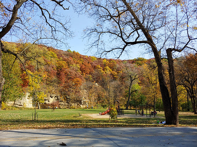 "Where kids come to play and adults come to remember how." A picturesque playground nestled among fall foliage invites multi-generational fun.