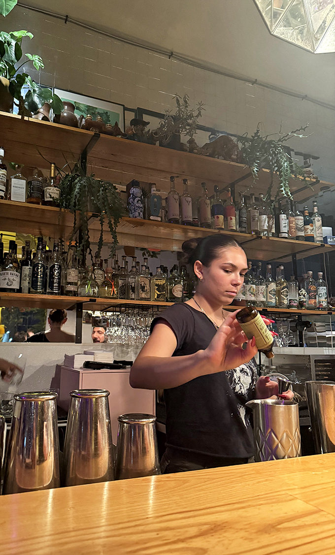Behind the bar, where liquid magic happens. This mixologist could give Hogwarts a run for its money.