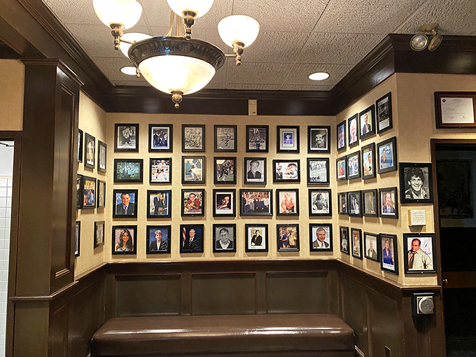 A wall of fame that tells more stories than your grandpa after his third whiskey. Each photo, a slice of Frank's rich history.