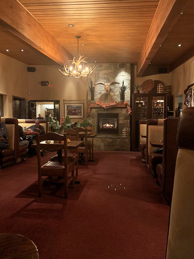 Fireplace? Check. Antler chandelier? You betcha. This room's got more Western charm than a rodeo queen on parade day.