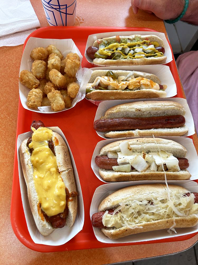 Hot dog heaven! This tray of dressed-up dogs is like a United Nations of flavor, bringing world peace one bite at a time.