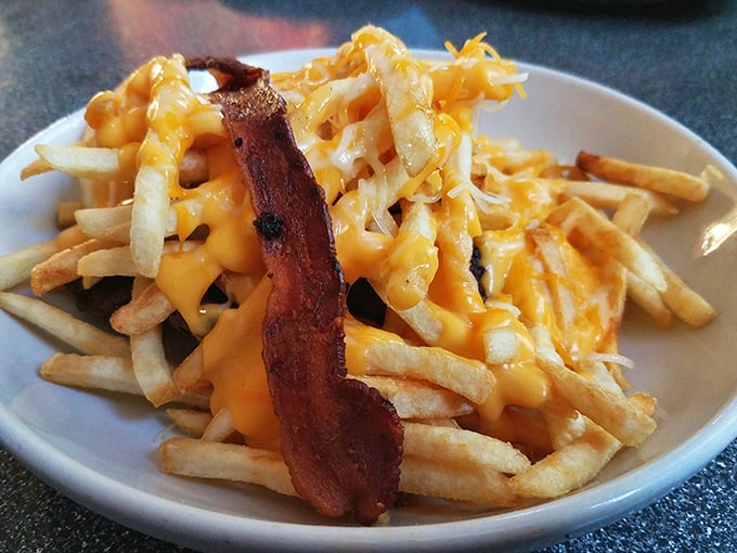 Cheesy fries that could make a cardiologist cry... tears of joy (in moderation, of course). That bacon's not messing around!
