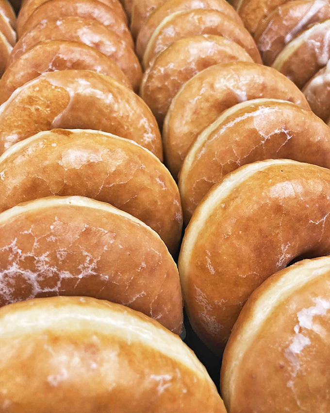 Behold the golden army of donuts, standing at attention and ready to be deployed directly to your taste buds. Resistance is futile!