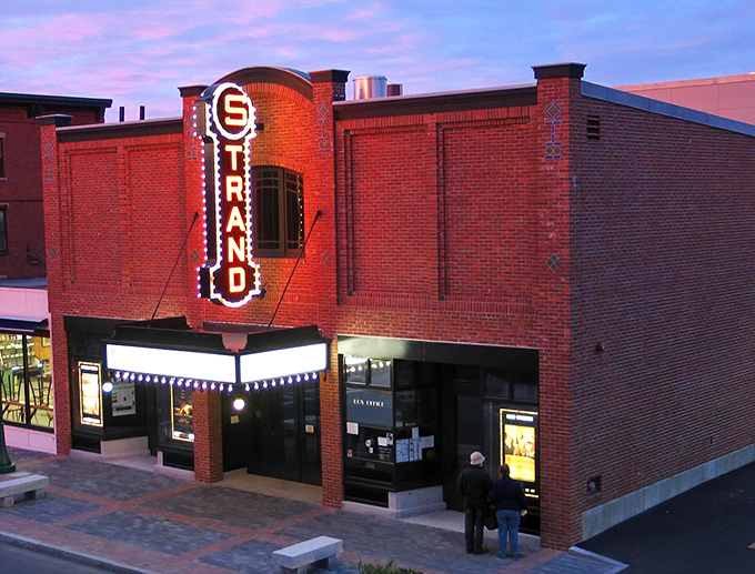 As the sun sets, the Strand's neon sign flickers to life, a beacon of entertainment in the heart of Rockland. Cue the dramatic music!