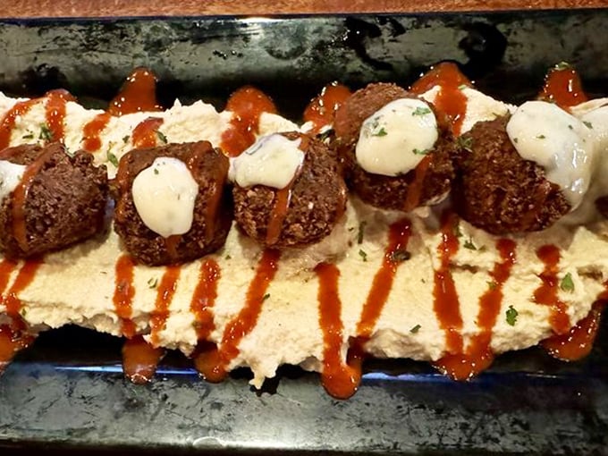 Savor every bite of these crispy falafel gems nestled on creamy hummus and drizzled with a perfect touch of spice.